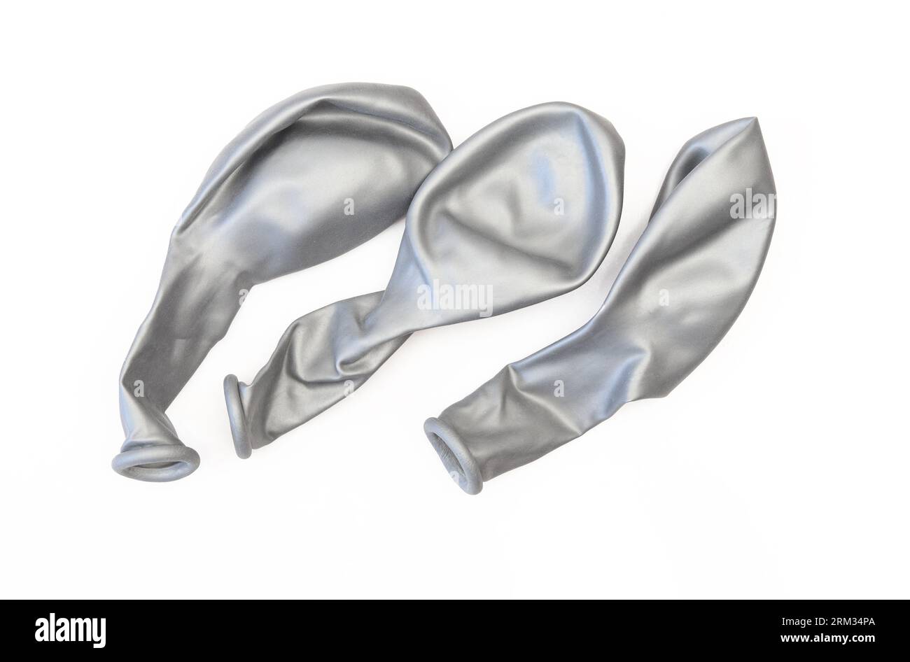 Three deflated decorative grey balloons isolated on white background ...