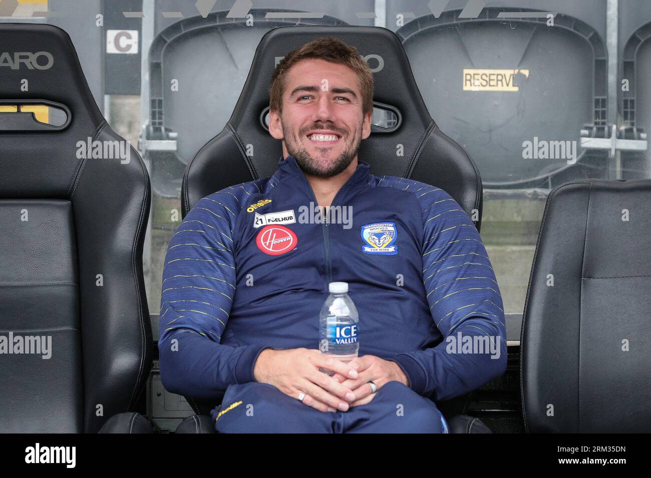 Greg Minikin #21 of Warrington Wolves sits on the bench ahead of the ...