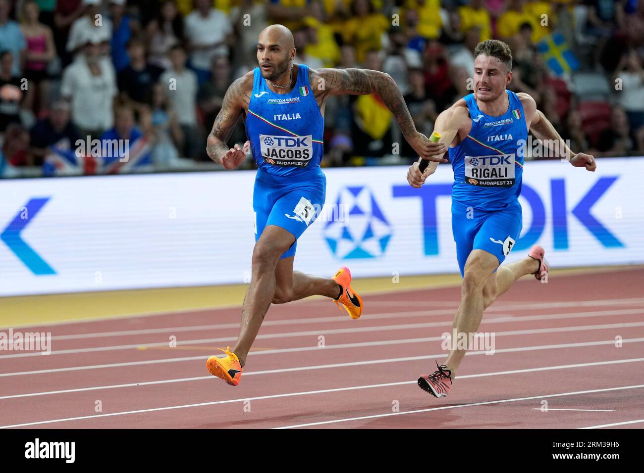 Lamont Marcell Jacobs, of Italy, takes the baton from teammate Roberto ...