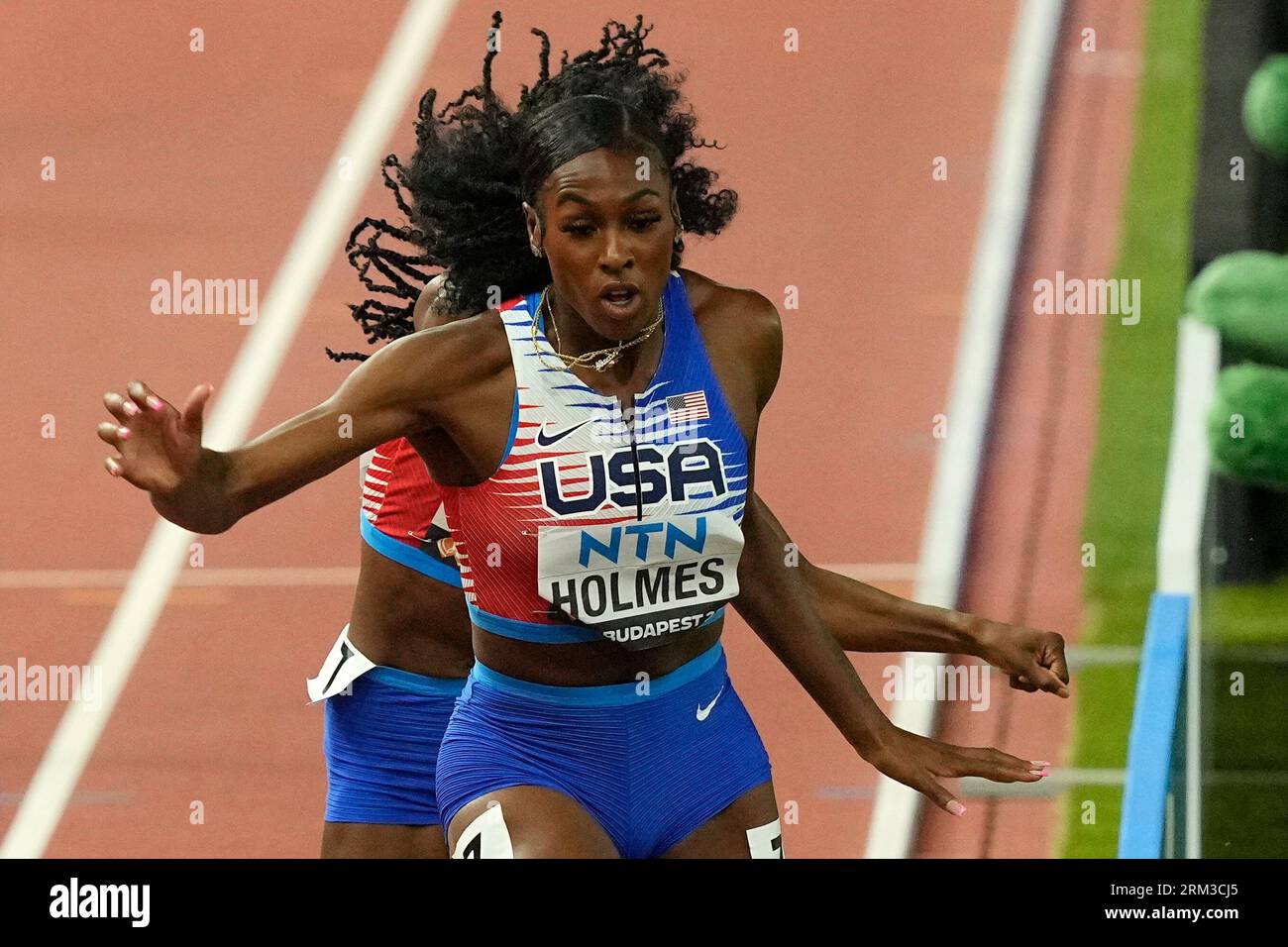 Alexis Holmes, of the United States, misses to get the baton from ...