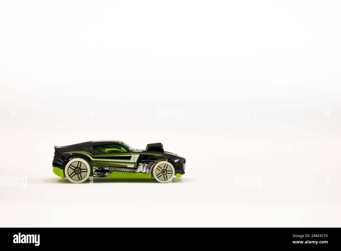 Black-green toy car isolated on a white background. Shot from side view ...