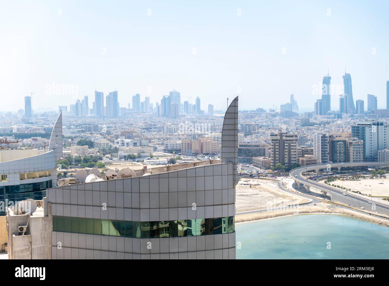 Manama city, Bahrain, top view through the buildings rooftops. Bahrain ...