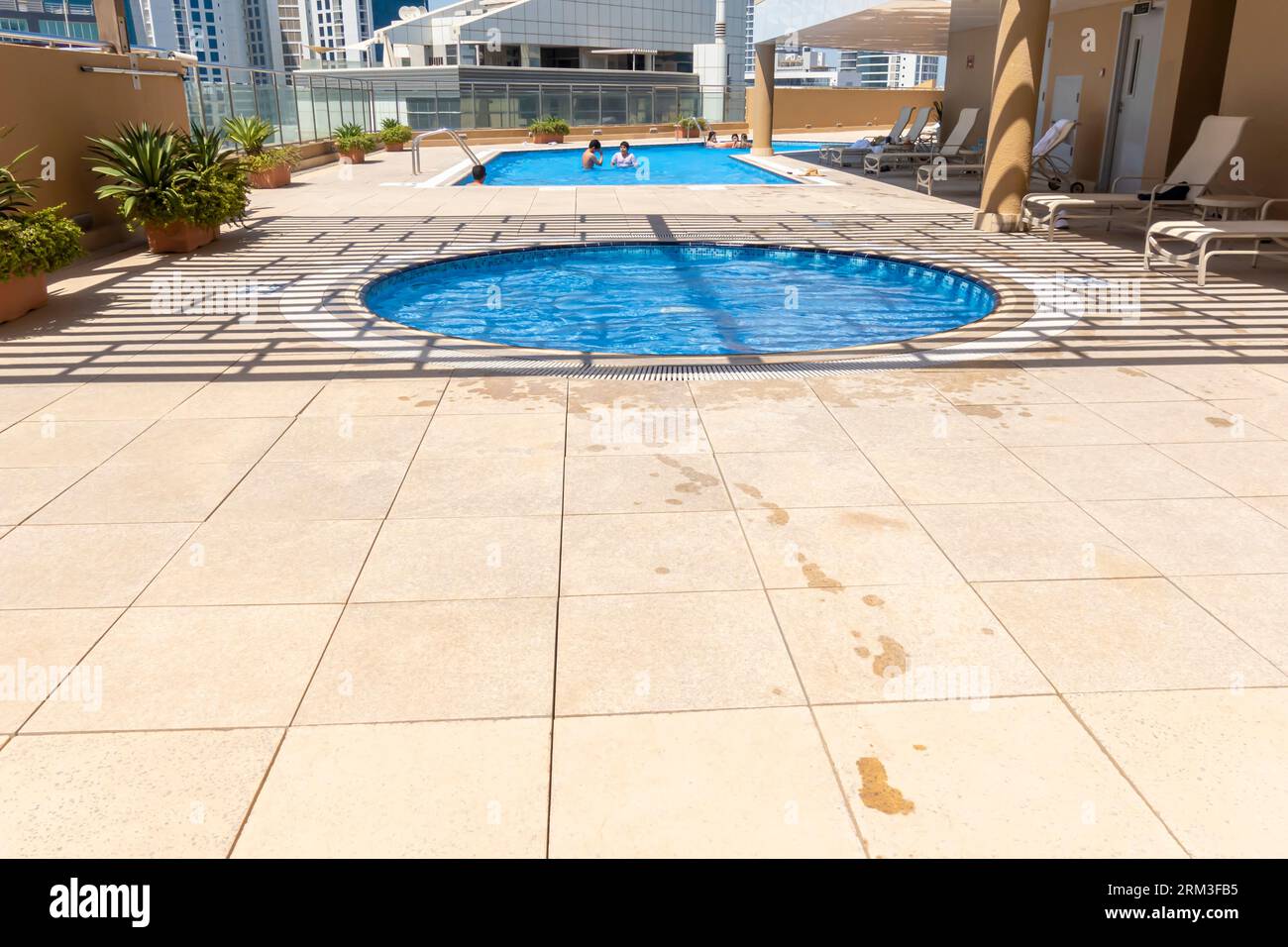 Rooftop double pool, wet water traces from feet Stock Photo - Alamy
