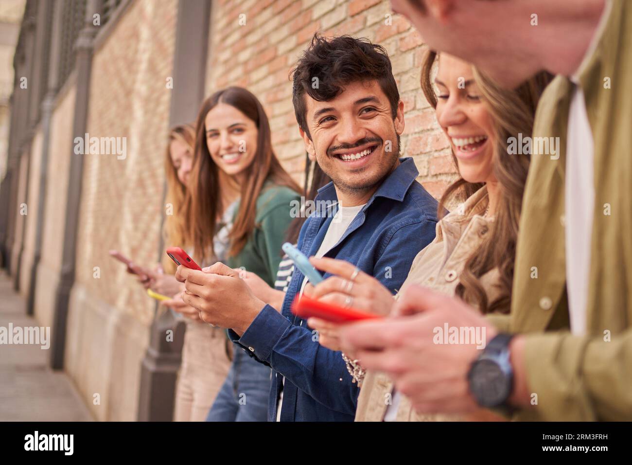 Side view multiracial smiling group young generation z leaning brick ...