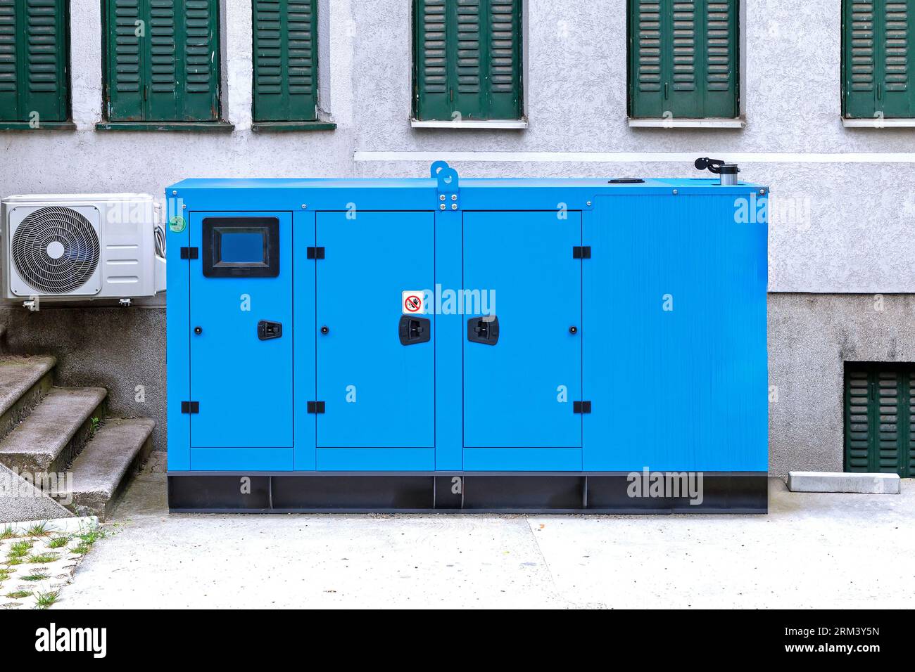 Auxiliary electric power generator stored behind the building Stock ...