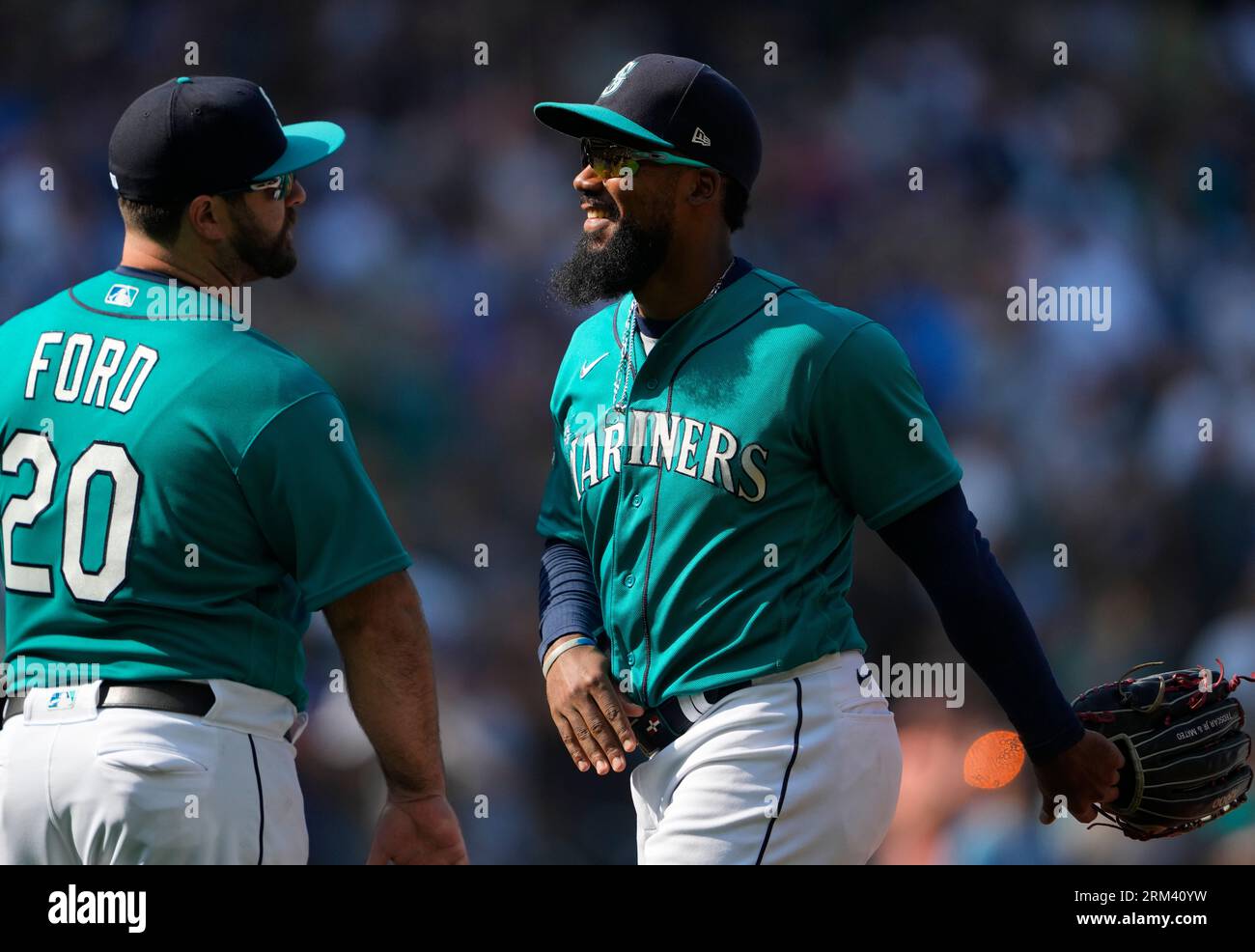 Seattle Mariners designated hitter Mike Ford (20) greets right fielder ...