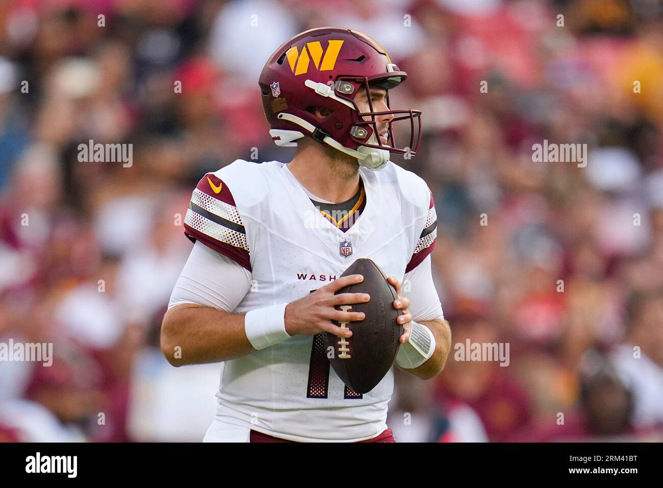 Washington Commanders quarterback Jake Fromm (11) looking down field to ...