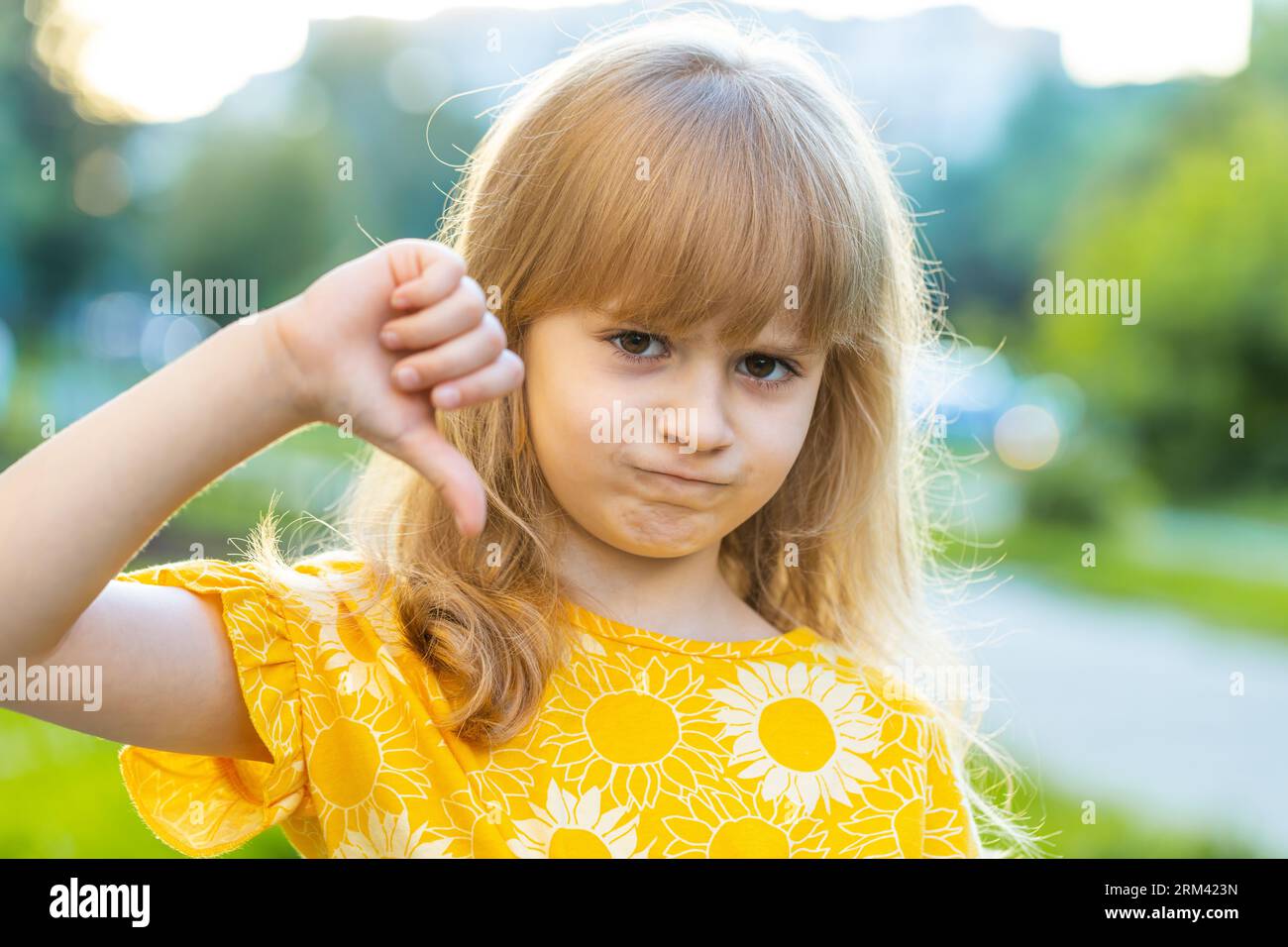 Dislike. Upset preteen child kid showing thumbs down sign gesture ...