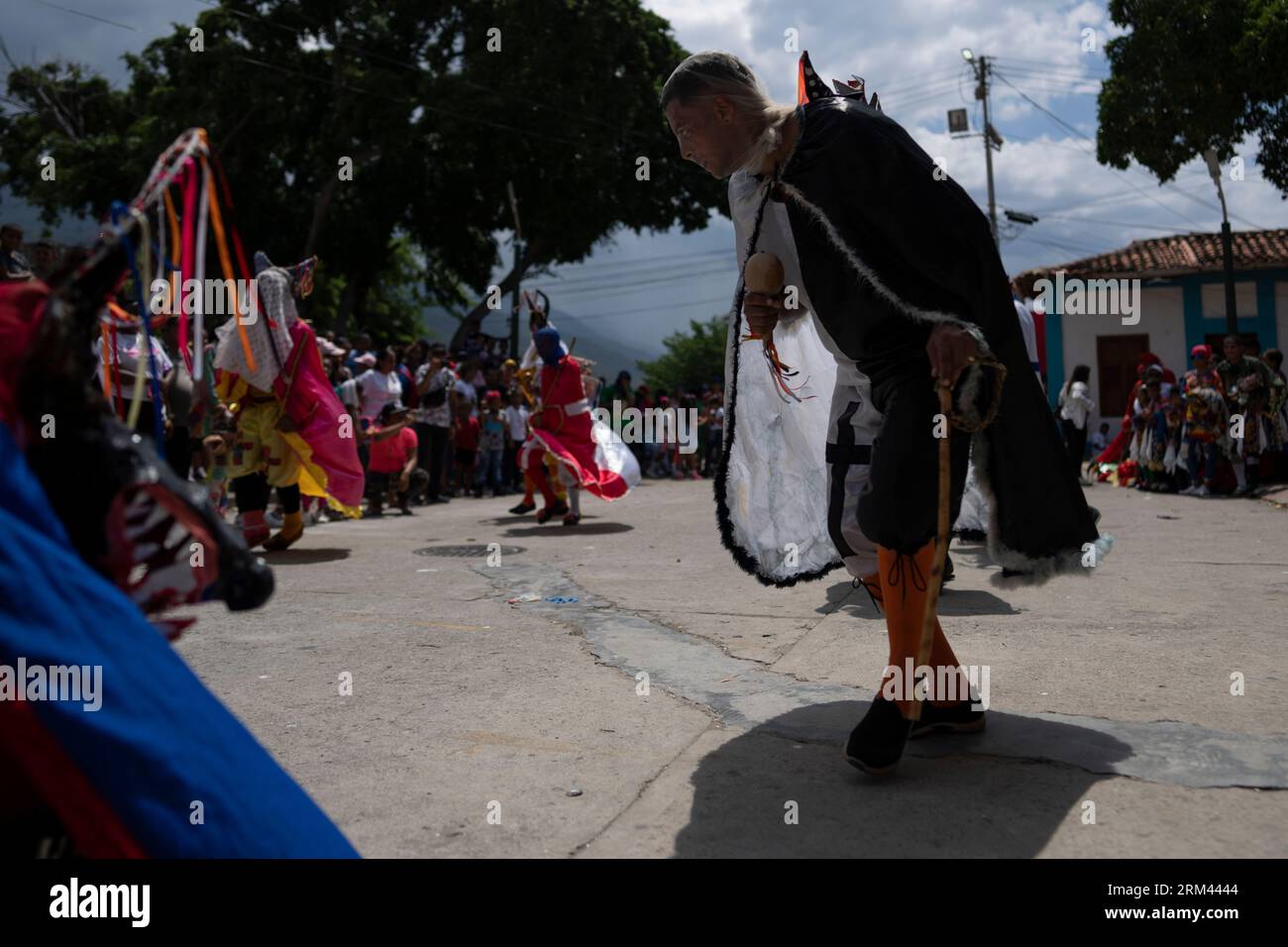 A man dressed in a devil costume from the Patanemo brotherhood dances ...