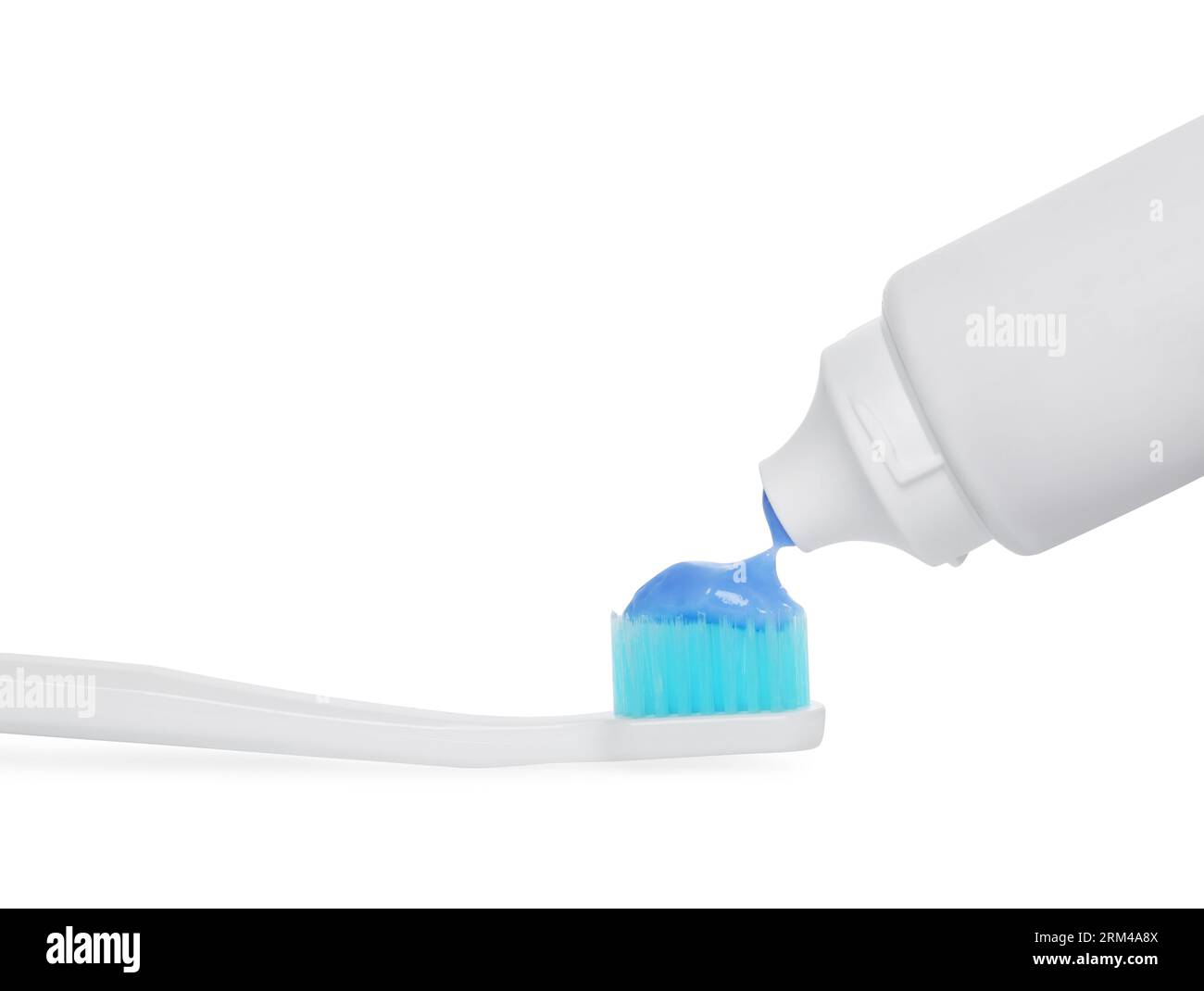 Applying paste on toothbrush against white background Stock Photo - Alamy