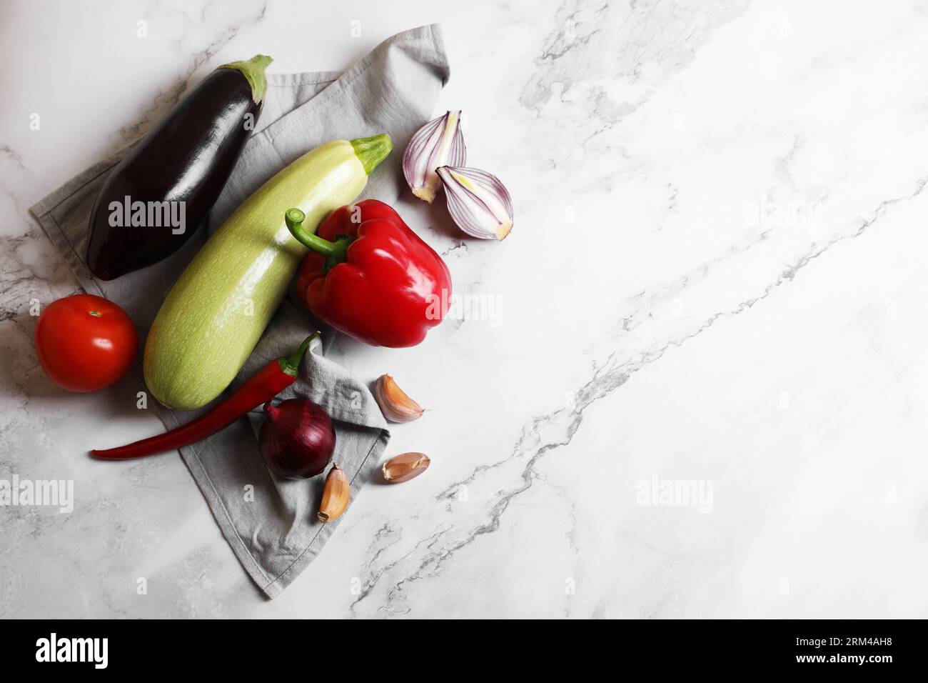 Fresh vegetables for ratatouille on white marble table, flat lay. Space ...