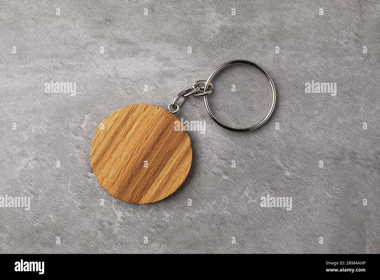 Wooden keychain in shape of smiley face on grey background, top view ...