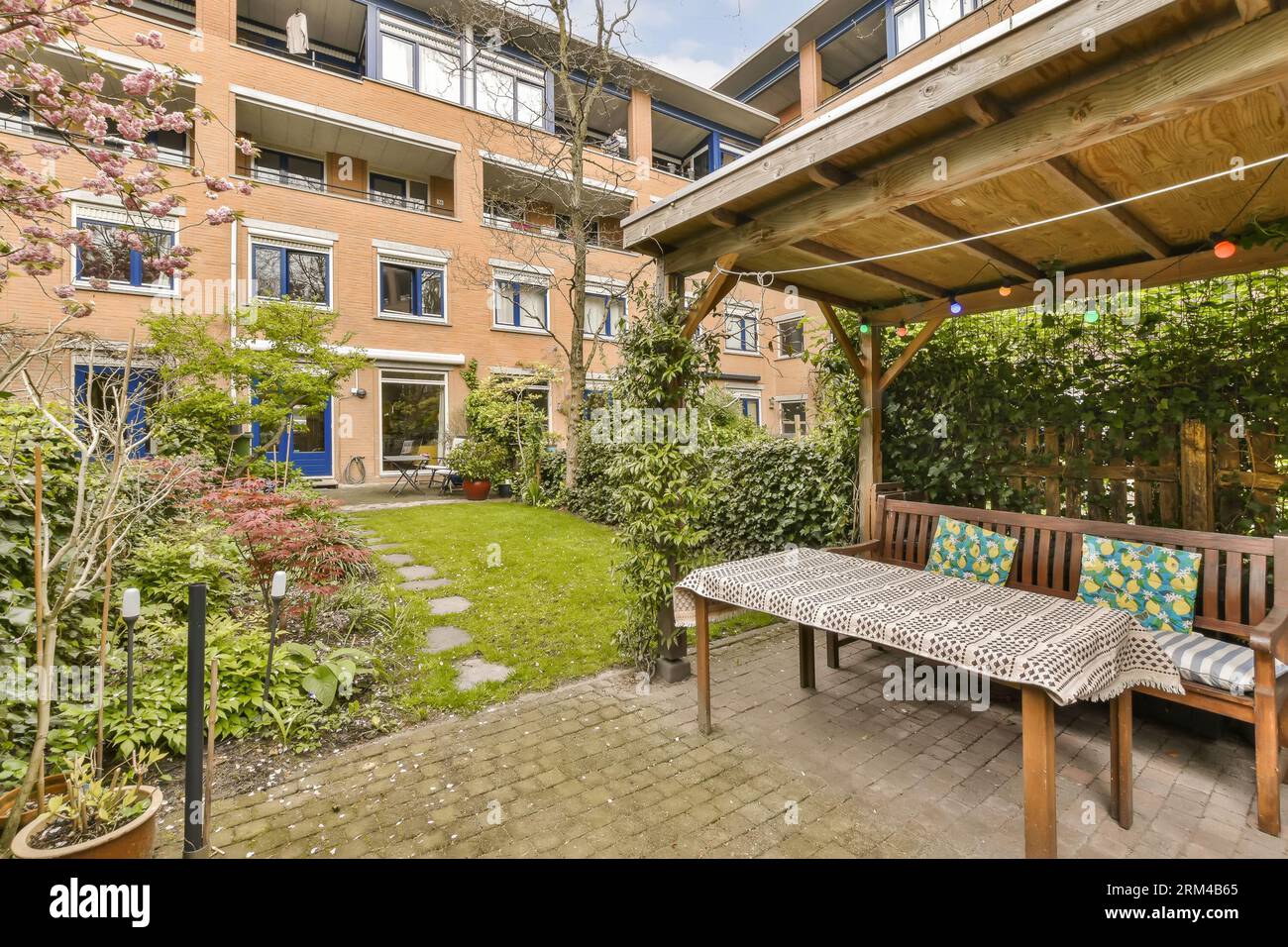 an outside area with a table and bench in the middle part of the yard ...