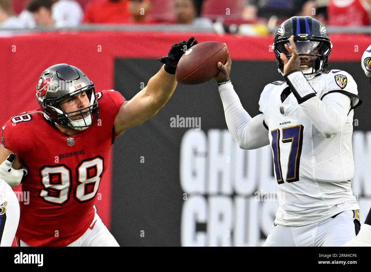 Tampa Bay Buccaneers linebacker Anthony Nelson, left, strips the ball ...