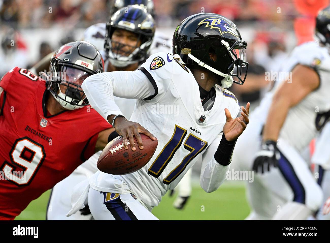 Baltimore Ravens quarterback Josh Johnson, right, runs away from Tampa ...