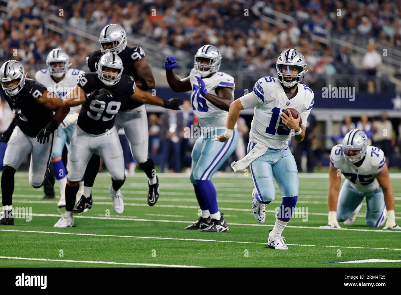 Dallas Cowboys quarterback Will Grier (15) keeps the ball for a gain as ...