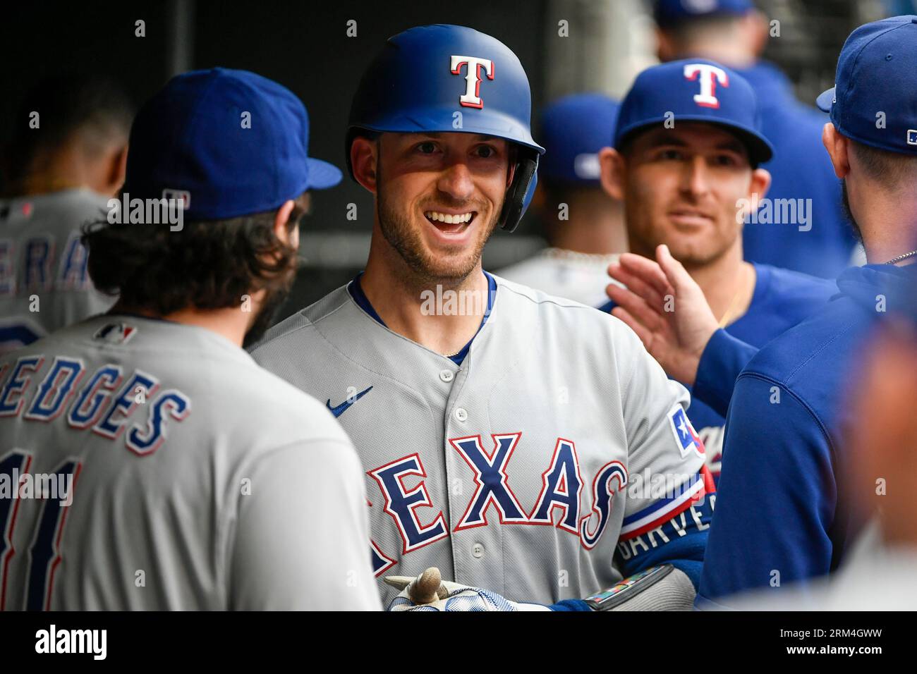 Texas Rangers' Mitch Garver celebrates in the dugout after hitting a ...