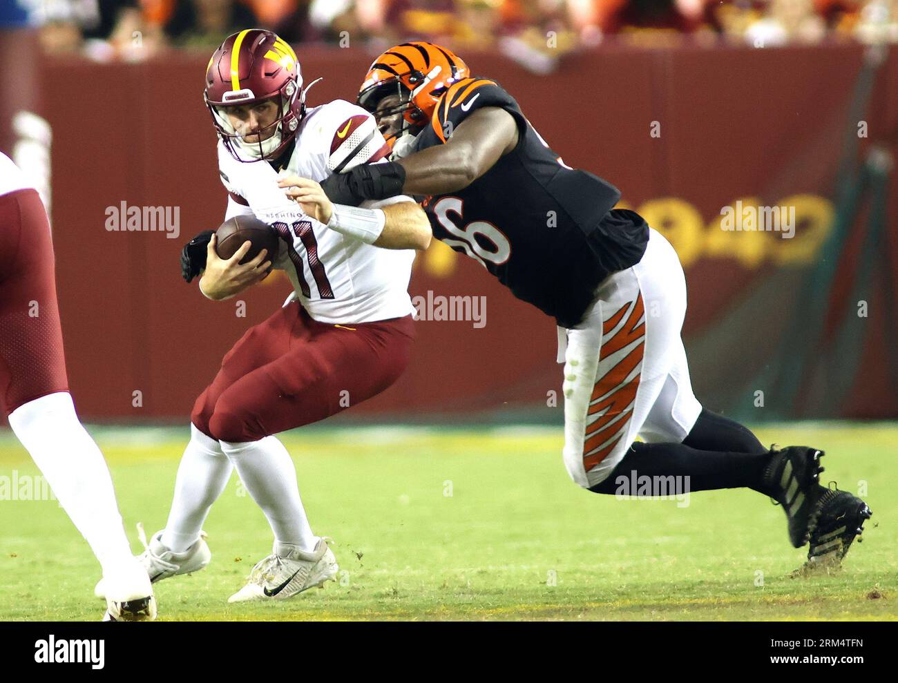 Cincinnati Bengals defensive end Raymond Johnson III (56) takes down ...