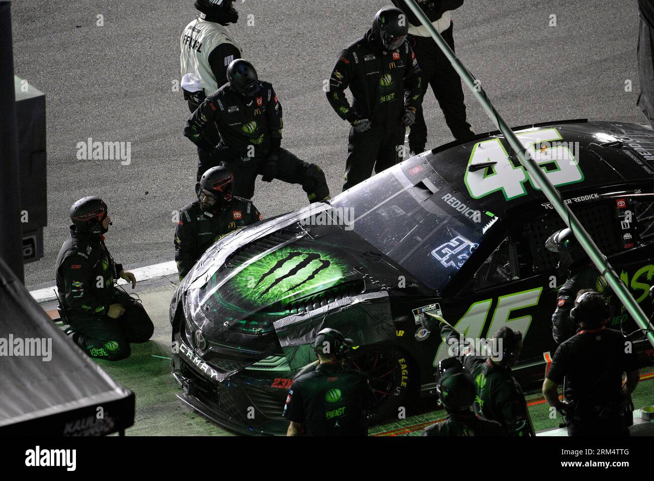Crew members look at Tyler Reddick's car on pit road during a red flag ...