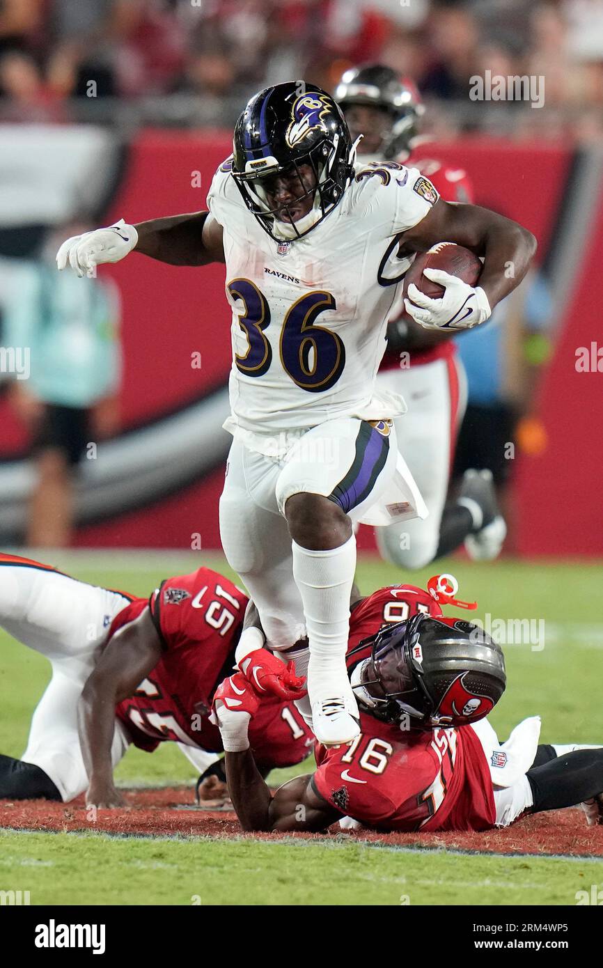 Baltimore Ravens running back Owen Wright, top, is stopped by Tampa Bay ...