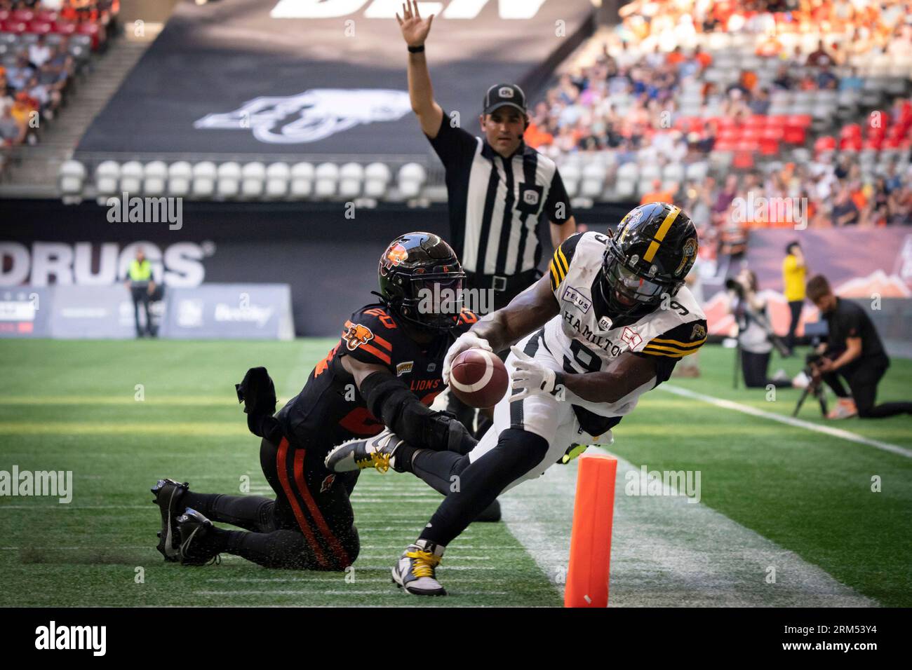 Hamilton Tiger-Cats running back James butler (9) scores a touchdown as ...