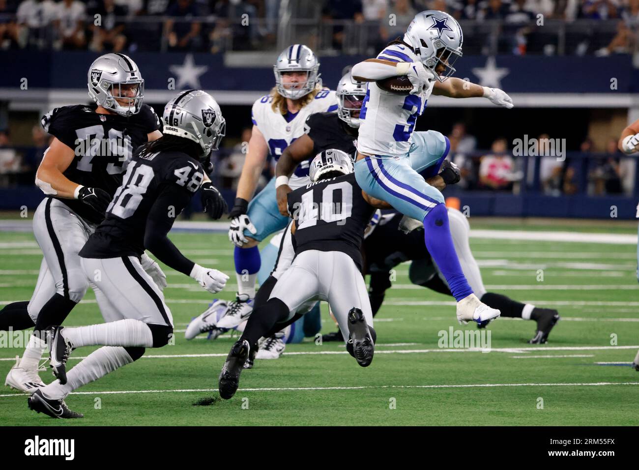Dallas Cowboys running back Malik Davis (34) leaps over Las Vegas ...