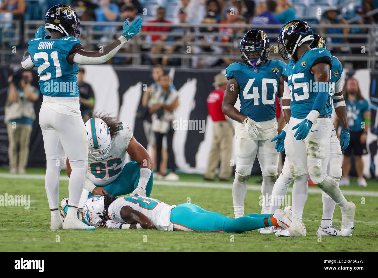 Miami Dolphins center Alama Uluave (62) kneels over Miami Dolphins wide ...