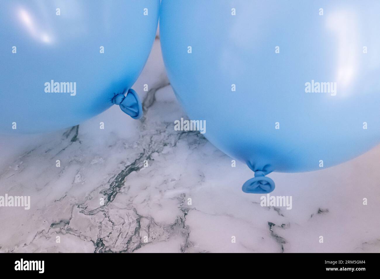 Natural lighted, daytime photoshoot of pastel balloons against a marble ...