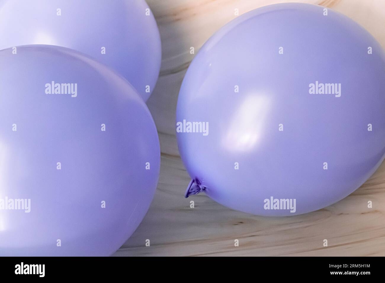 Natural lighted, daytime photoshoot of pastel balloons against a marble ...