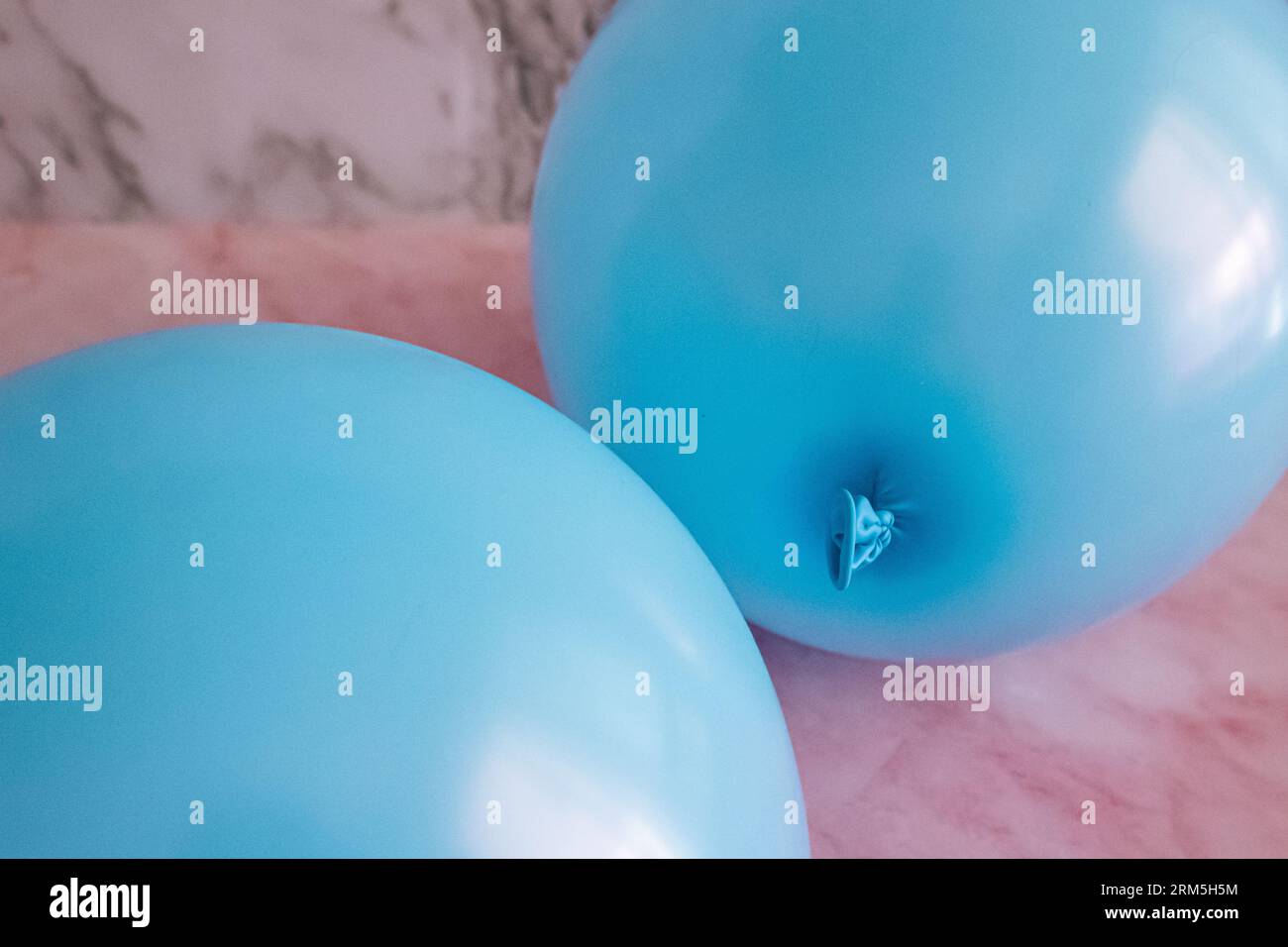 Natural lighted, daytime photoshoot of pastel balloons against a marble ...