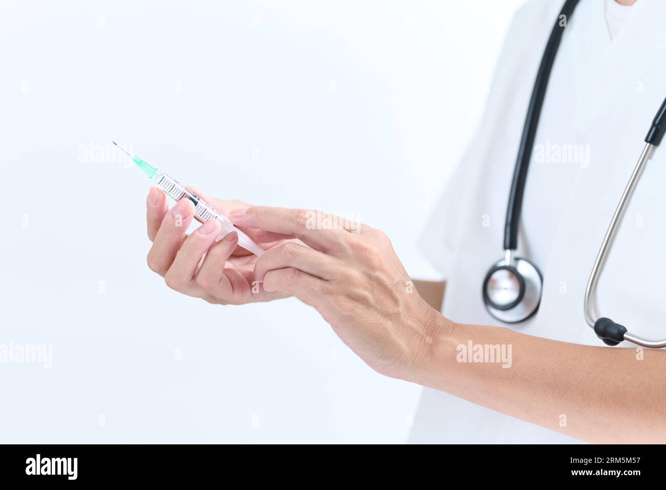 Asian doctor hand with syringe Stock Photo - Alamy