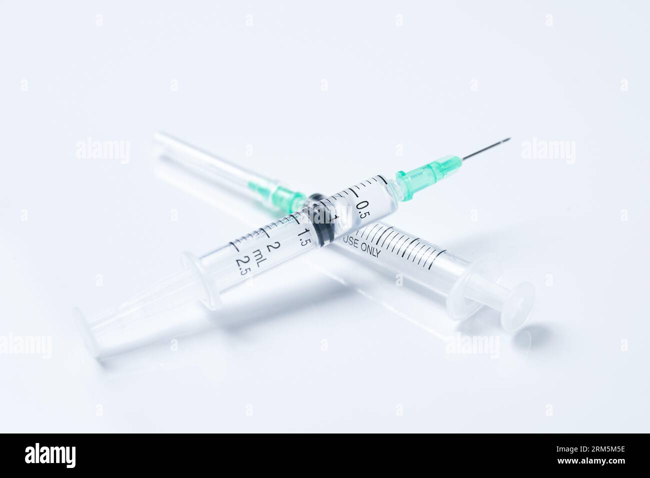 Two syringes on a white background Stock Photo - Alamy