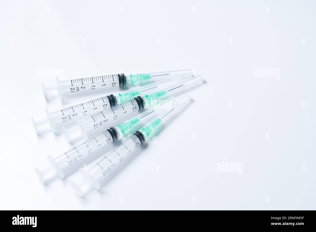 Multiple syringes placed on a white background Stock Photo - Alamy