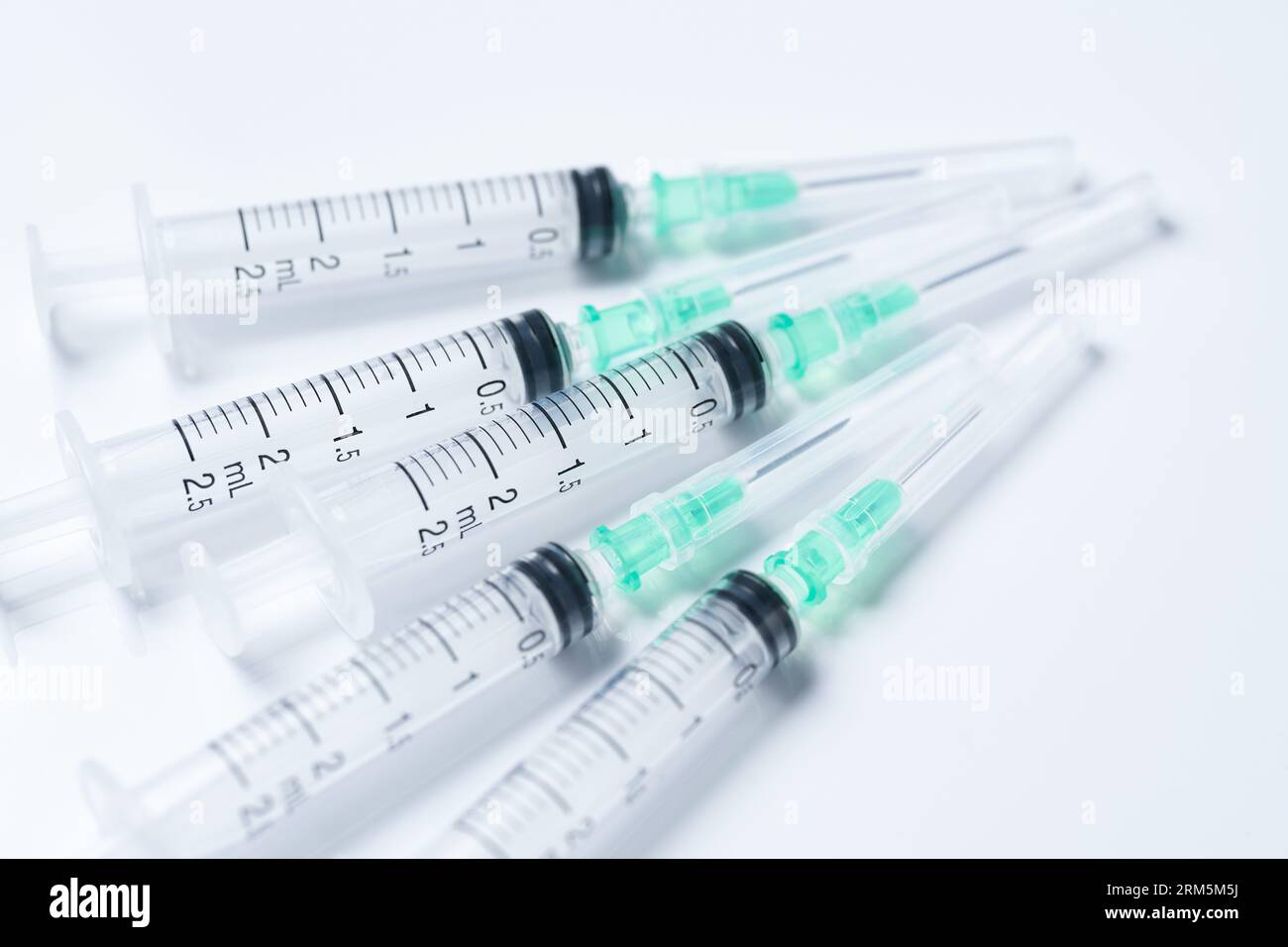 Multiple syringes placed on a white background Stock Photo - Alamy