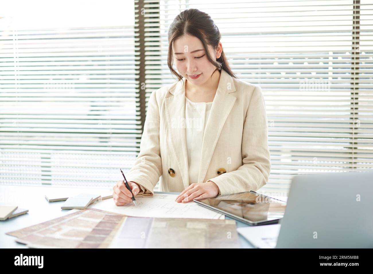 Asian interior designer thinking about home interior Stock Photo - Alamy