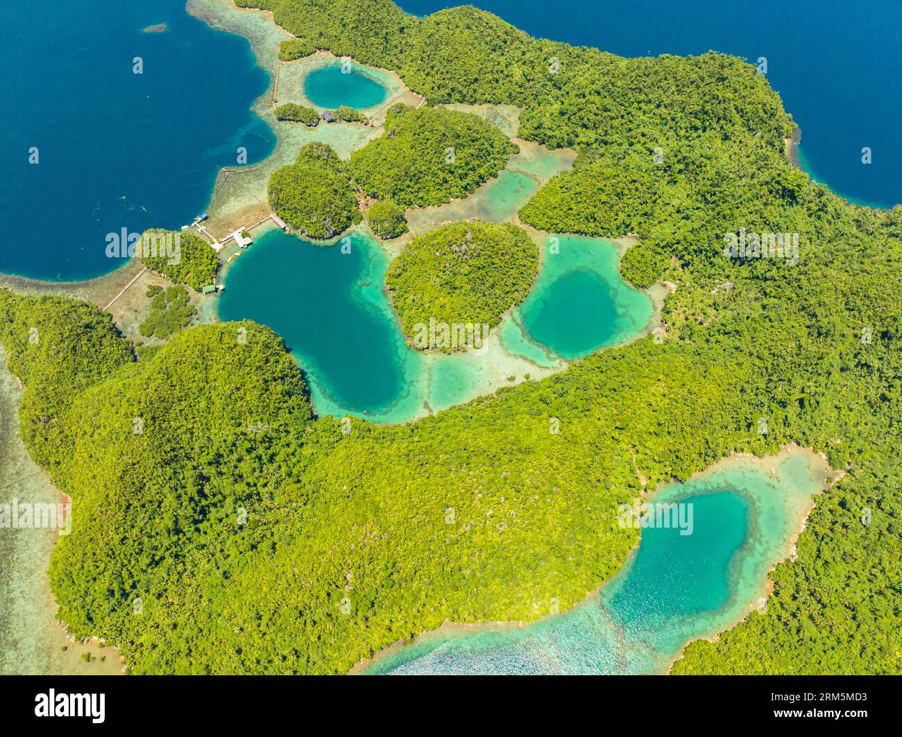 Flying above Tinago Island with rainforest and turquoise water lagoons ...
