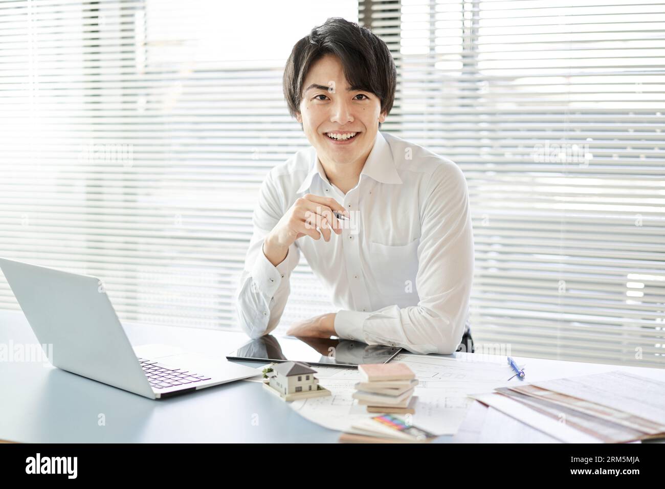 Asian male architect standing at a design office Stock Photo - Alamy