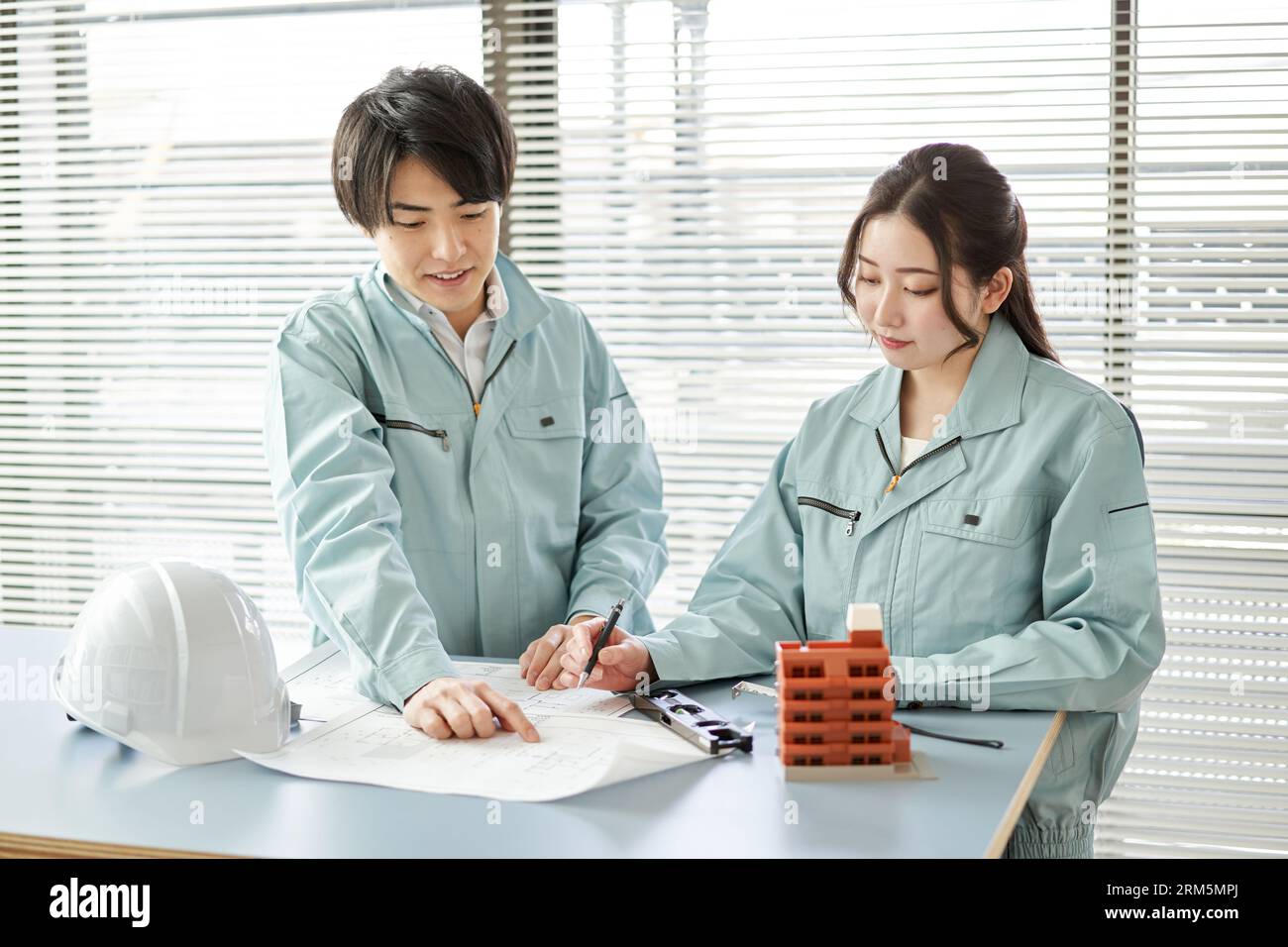 Asian workers having an architectural meeting Stock Photo - Alamy