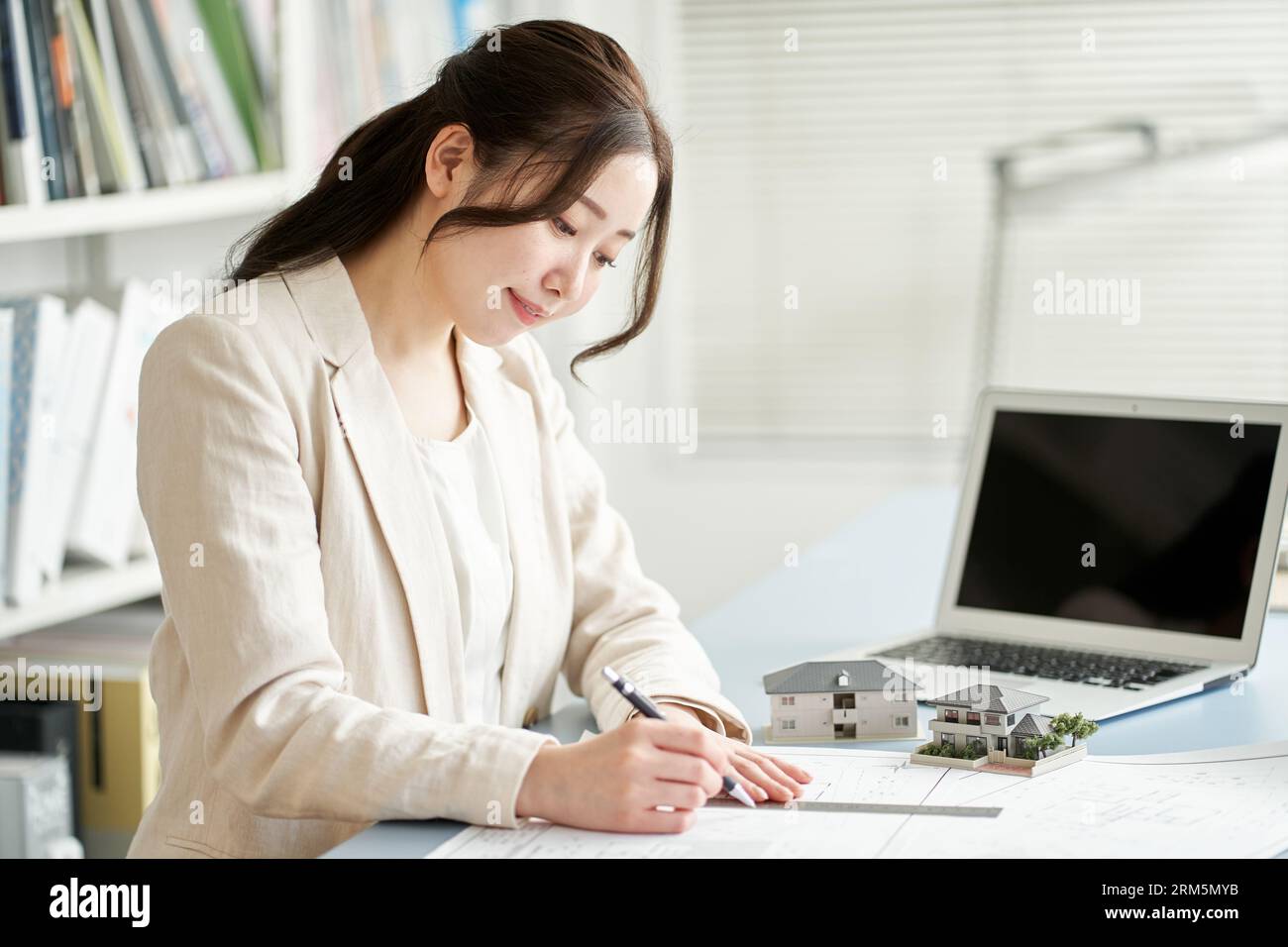 Female architect designing a house Stock Photo - Alamy