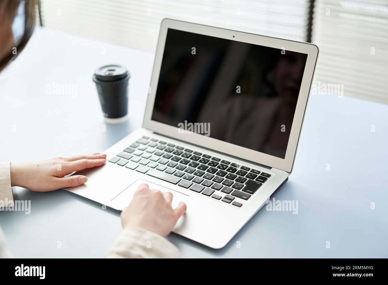 Asian woman operating a laptop Stock Photo - Alamy