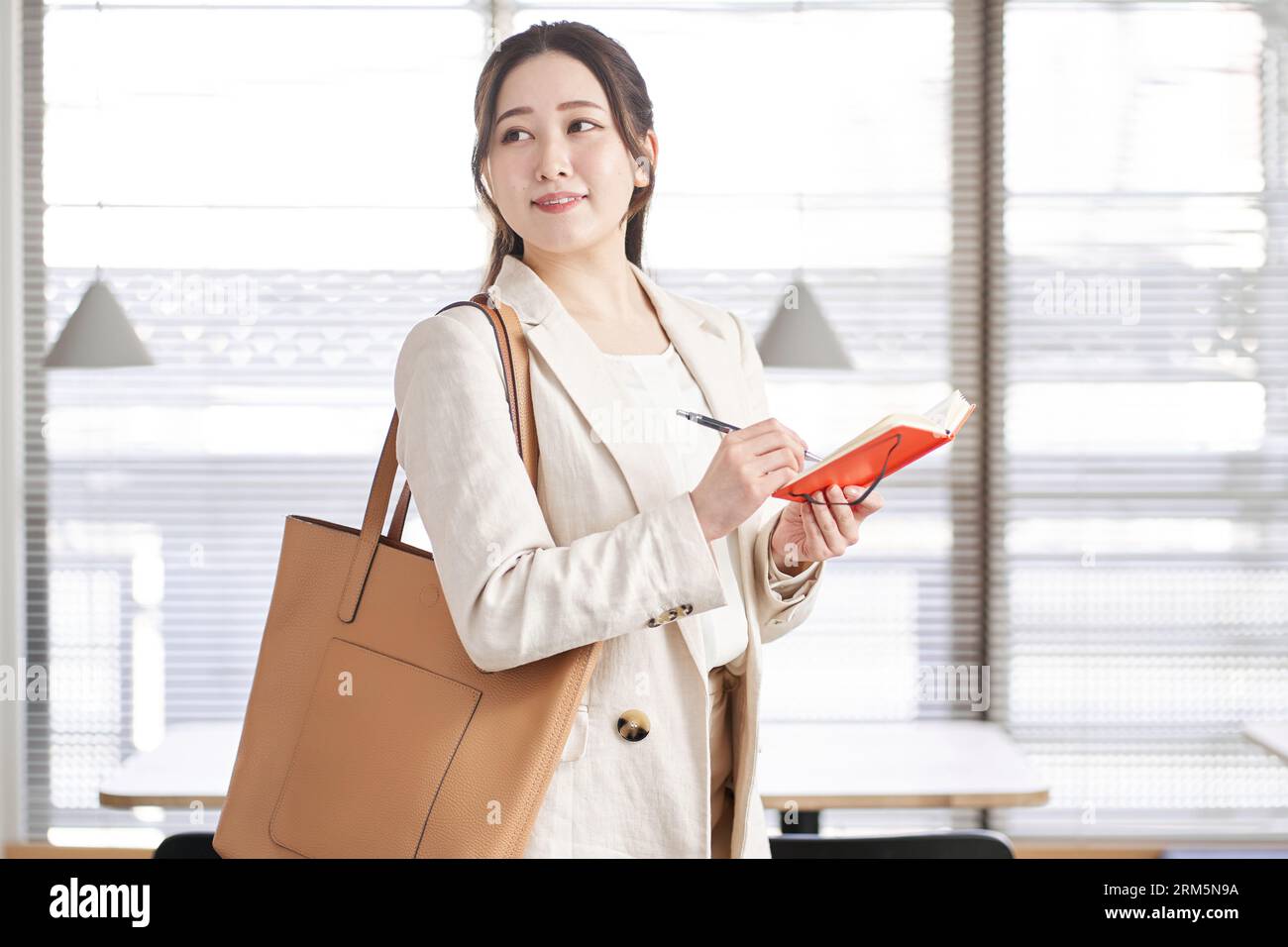 Check notes Asian business woman Stock Photo - Alamy