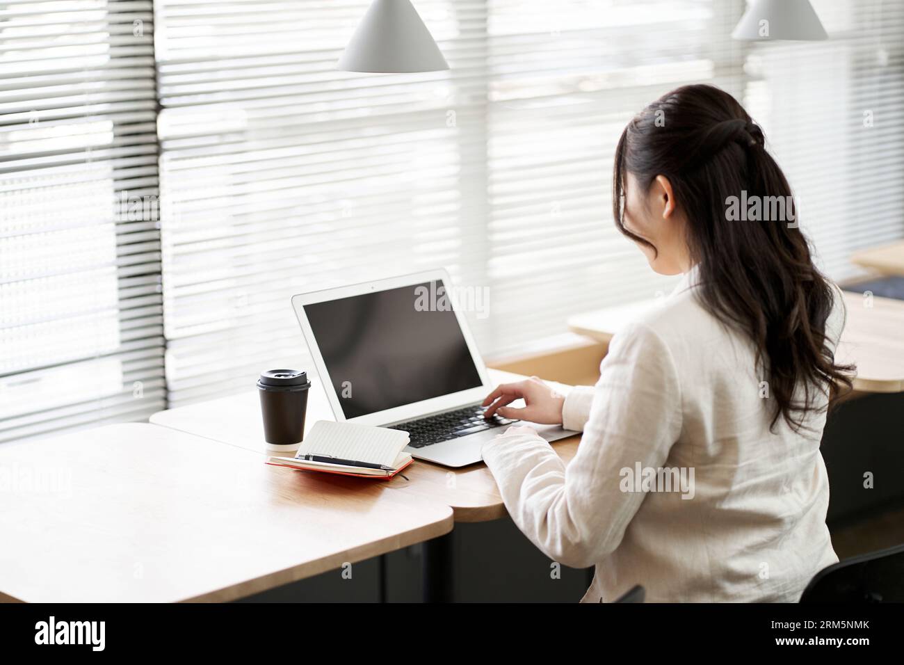 Asian woman computer back view cafe hi-res stock photography and images ...