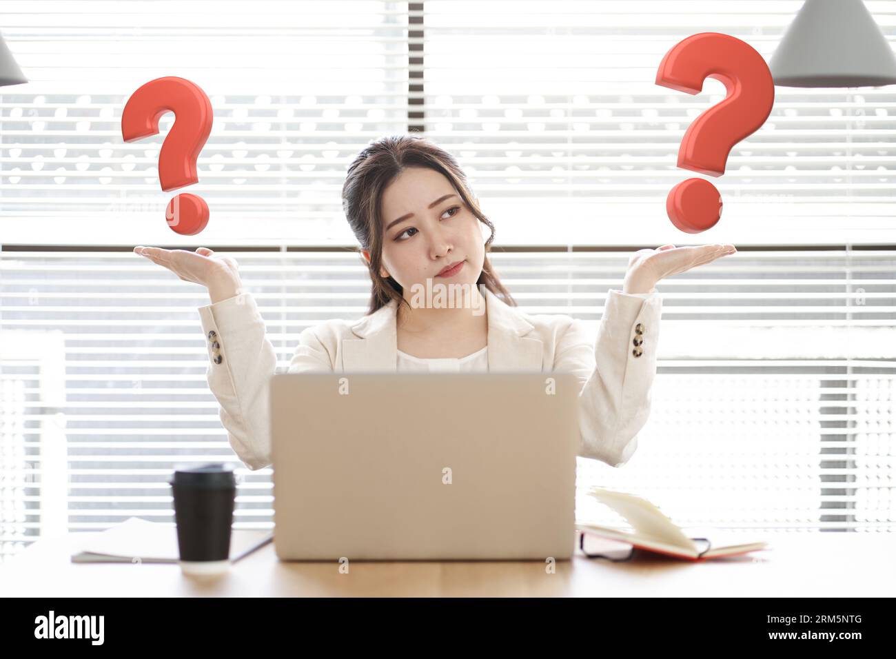 Asian women comparing question marks Stock Photo - Alamy