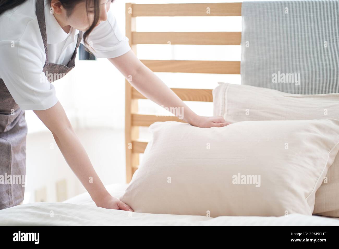Asian woman making a bed in the bedroom Stock Photo - Alamy
