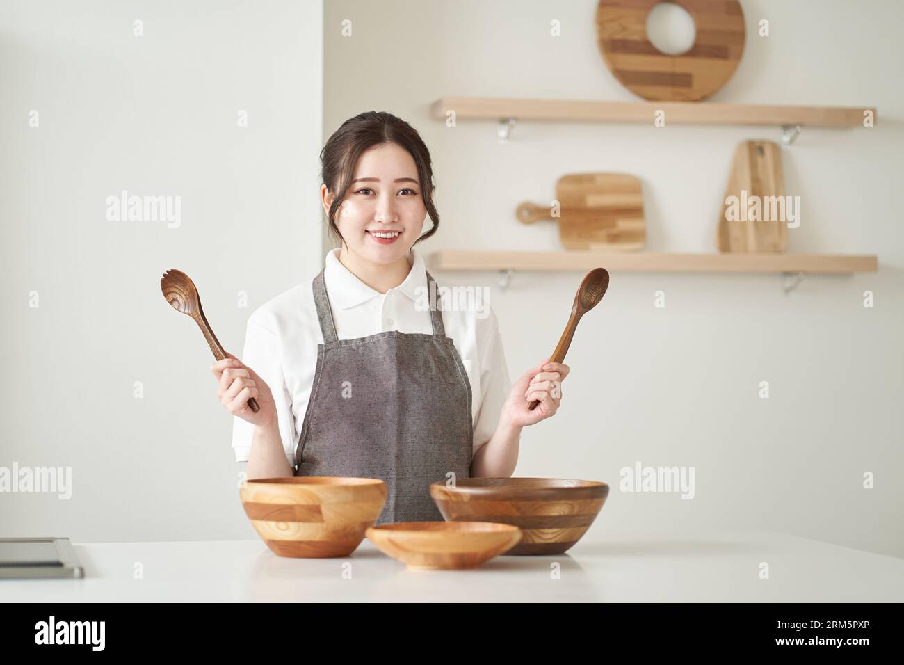 Asian woman cooking in the kitchen Stock Photo - Alamy