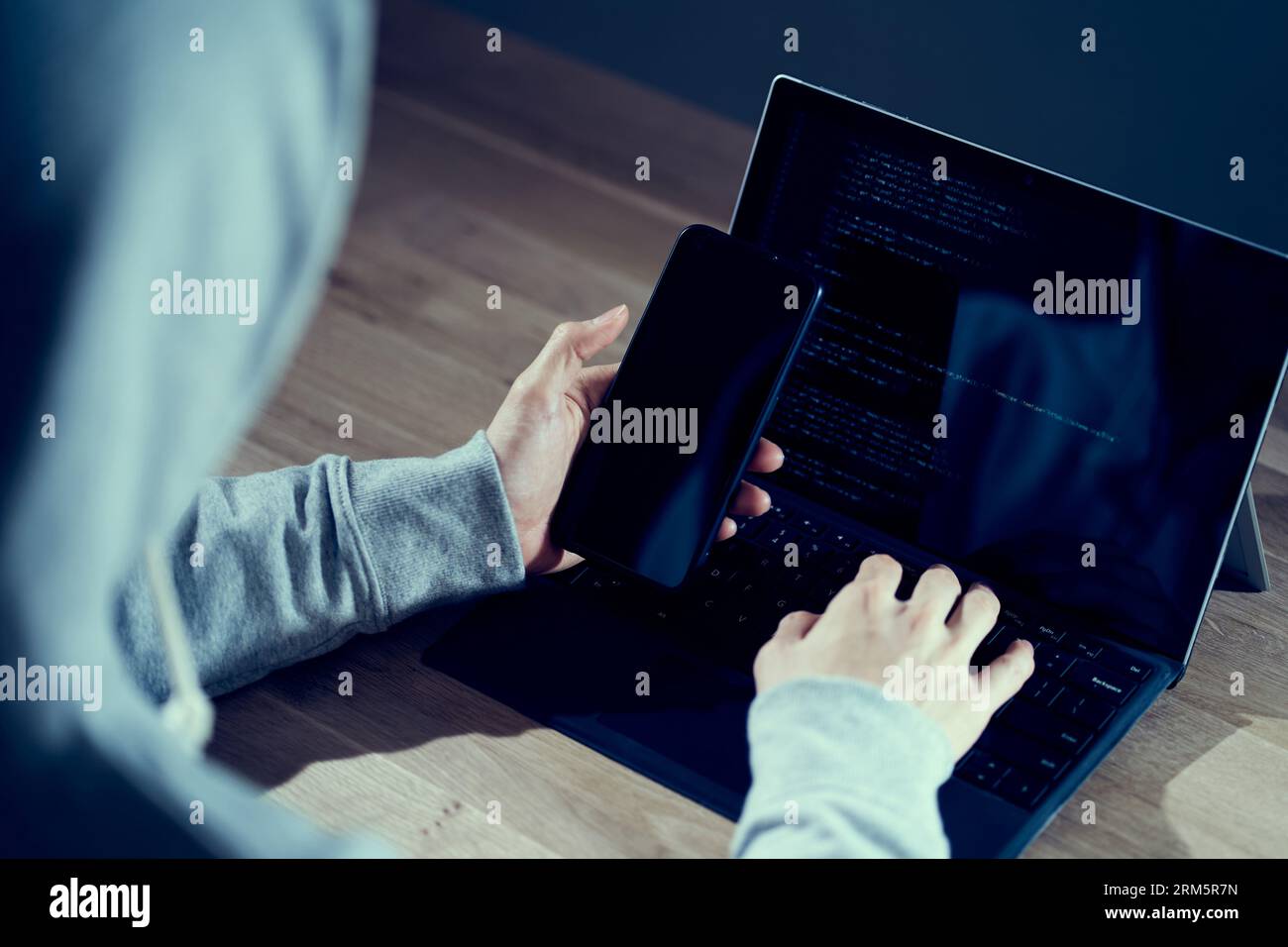 A male hacker checking the operation on a smartphone Stock Photo - Alamy