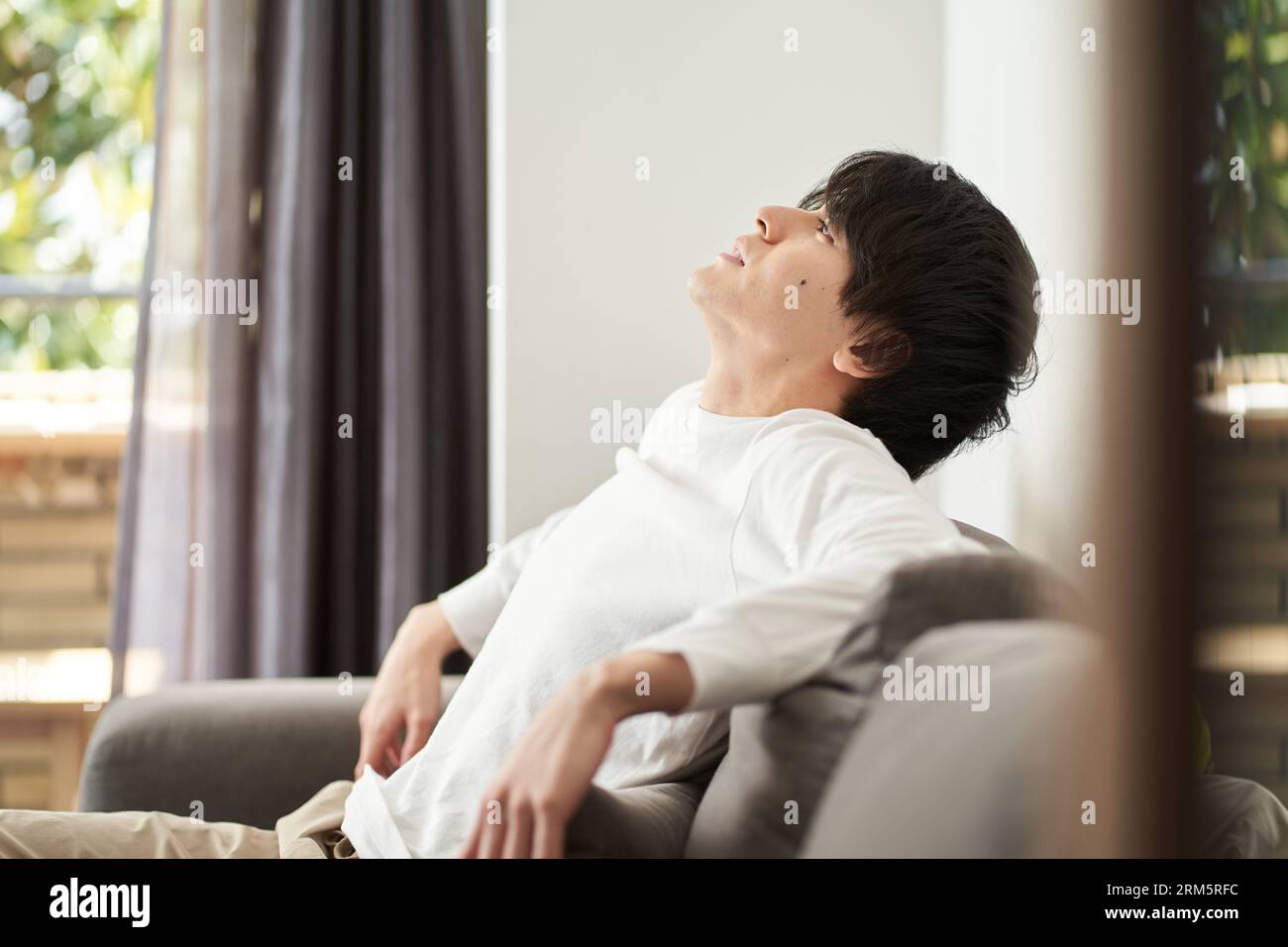 Asian man relaxing in hi-res stock photography and images - Alamy