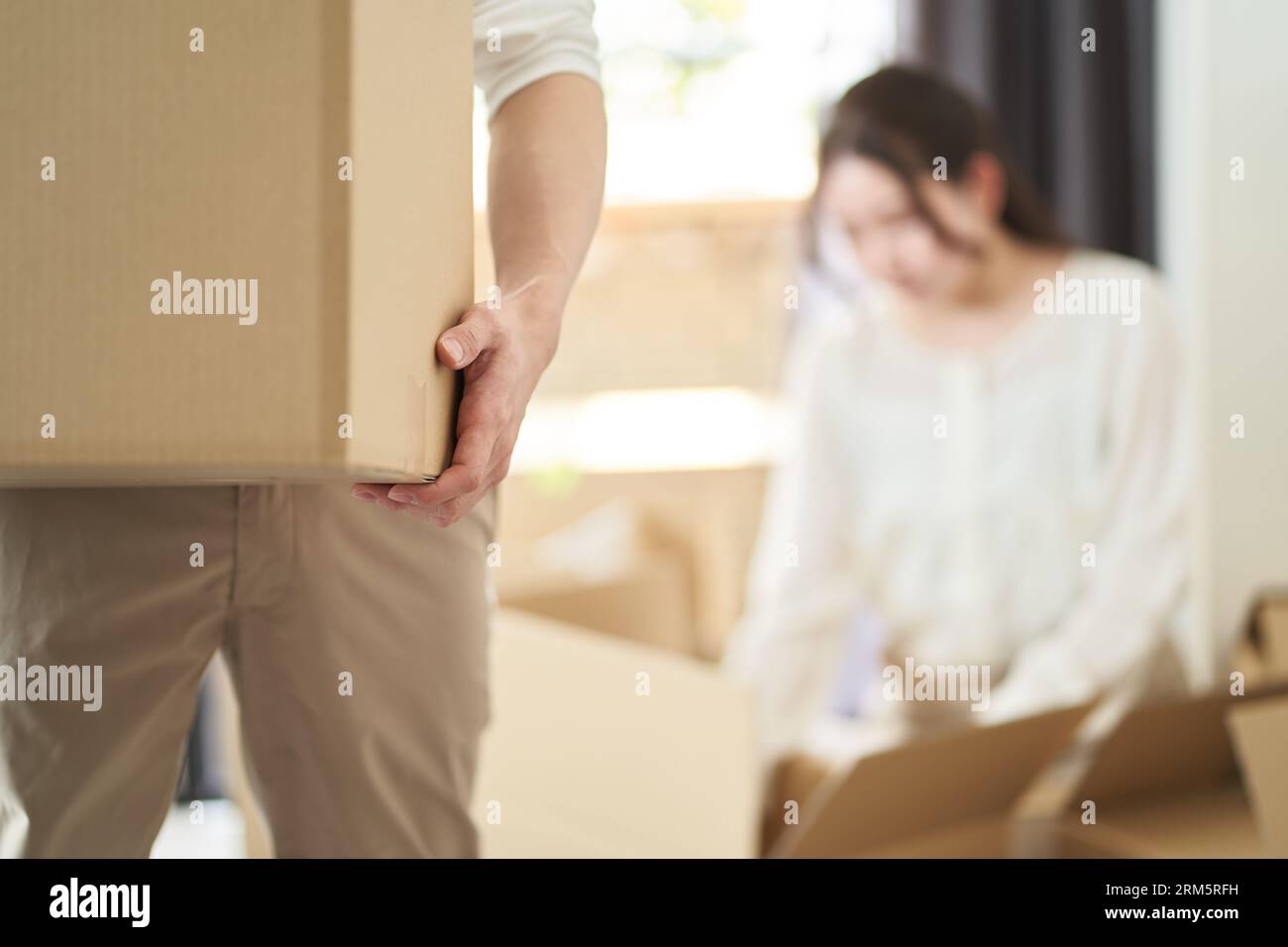 Asian men packing cardboard box hi-res stock photography and images - Alamy