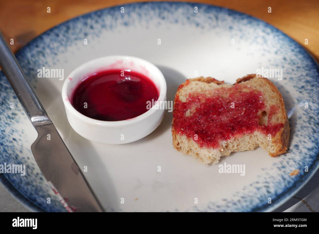 Spreading jam on on slice bread Stock Photo - Alamy