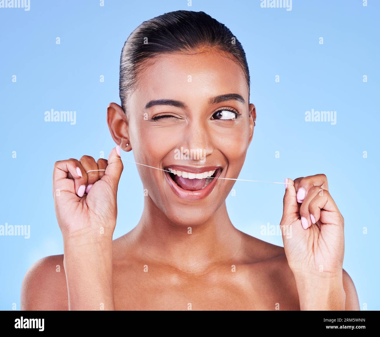 Woman, wink and floss teeth in studio for healthy dental care, gum ...